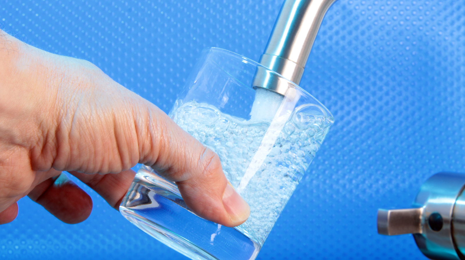 What White Flakes In Your Tap Water Really Mean